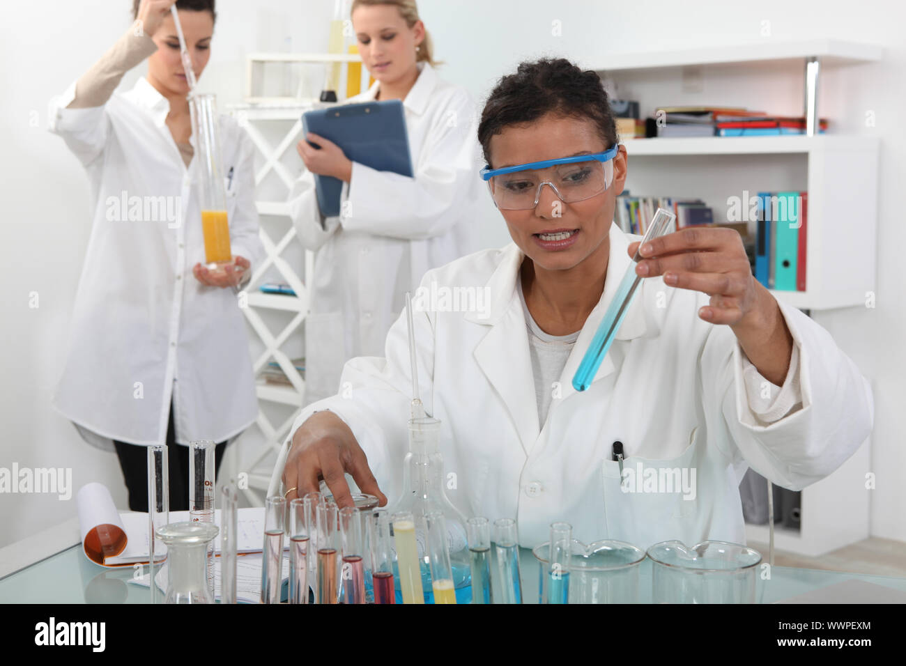 female trio in lab with test-tubes Stock Photo - Alamy