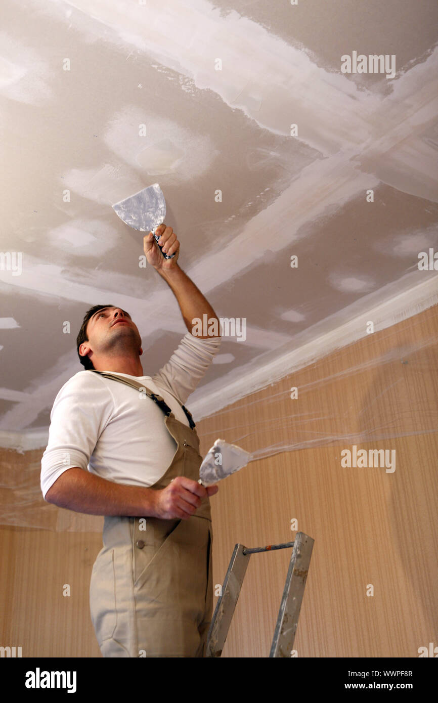 Plasterer working on ceiling Stock Photo - Alamy