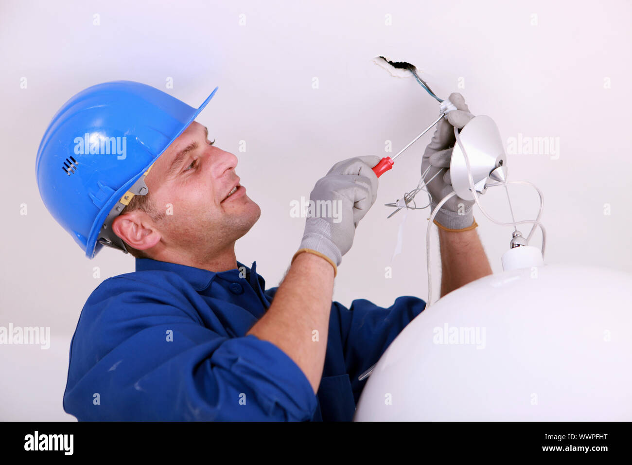 Electrician wiring a ceiling light Stock Photo - Alamy