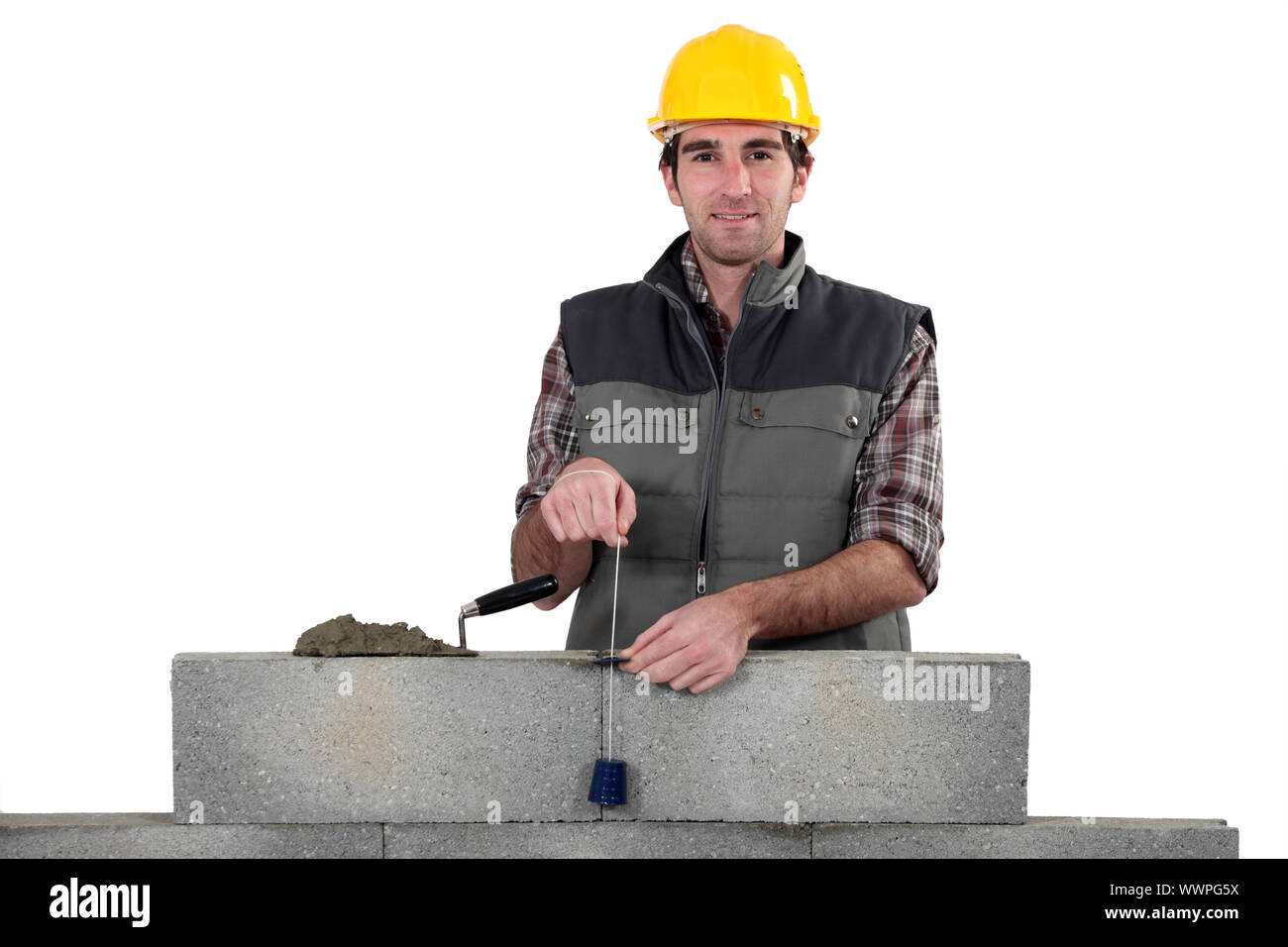 Bricklayer with a plumb line Stock Photo - Alamy