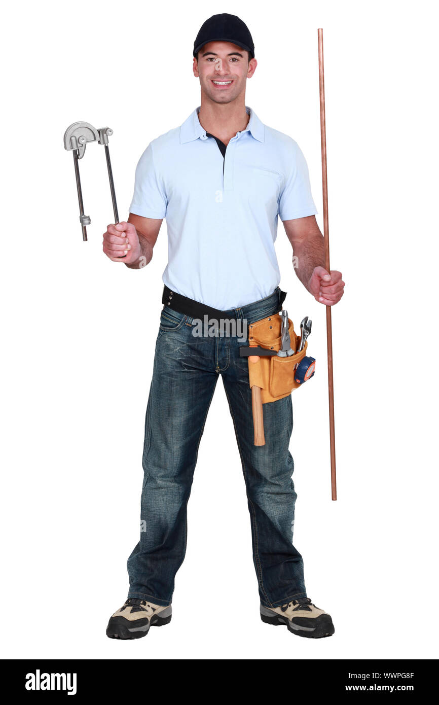 Plumber holding pipe and bending tool Stock Photo - Alamy
