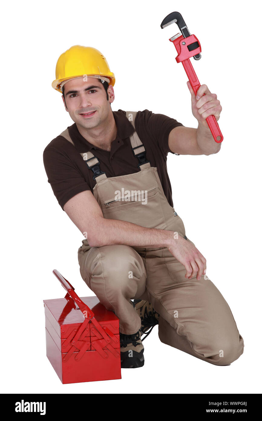 Man kneeling by tool box Stock Photo - Alamy