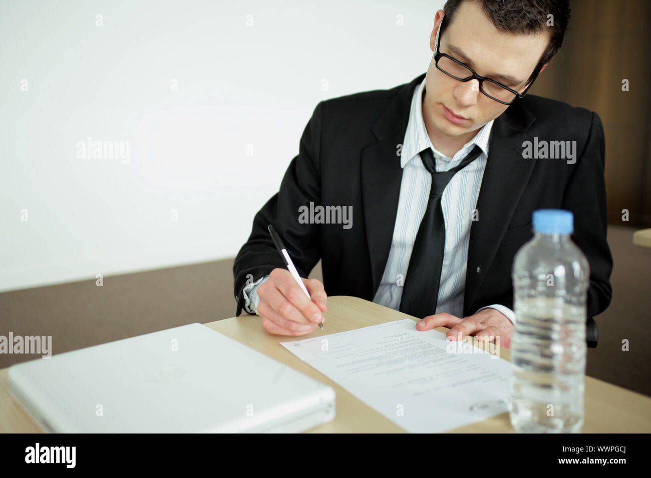 Young office worker doing paperwork Stock Photo - Alamy