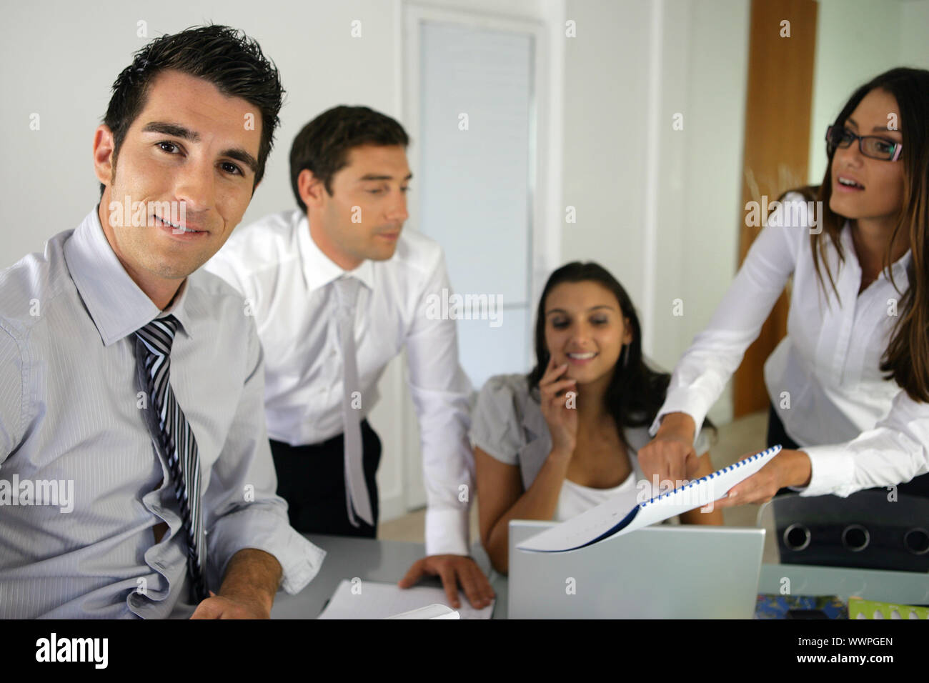 Office workers gathered around computer hi-res stock photography and ...