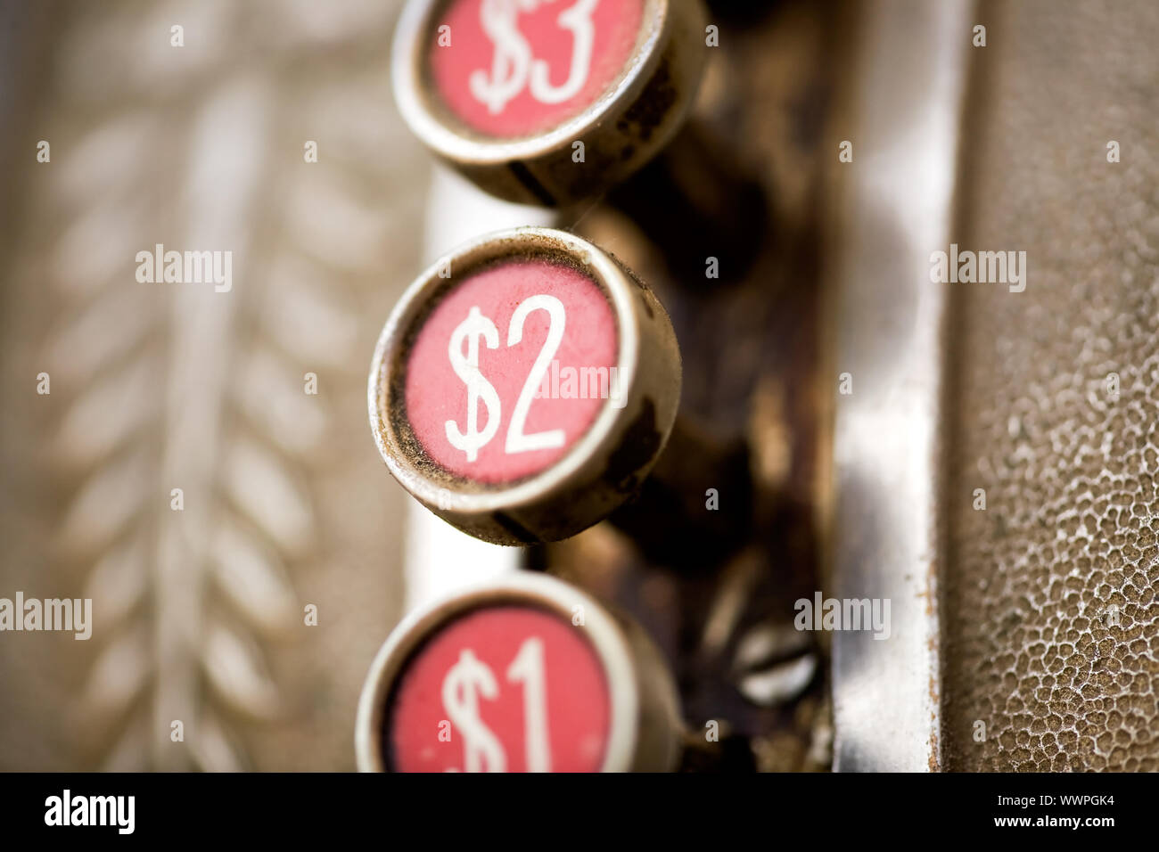 A 2 dollar button on a retro dirty cash register - shallow depth of ...