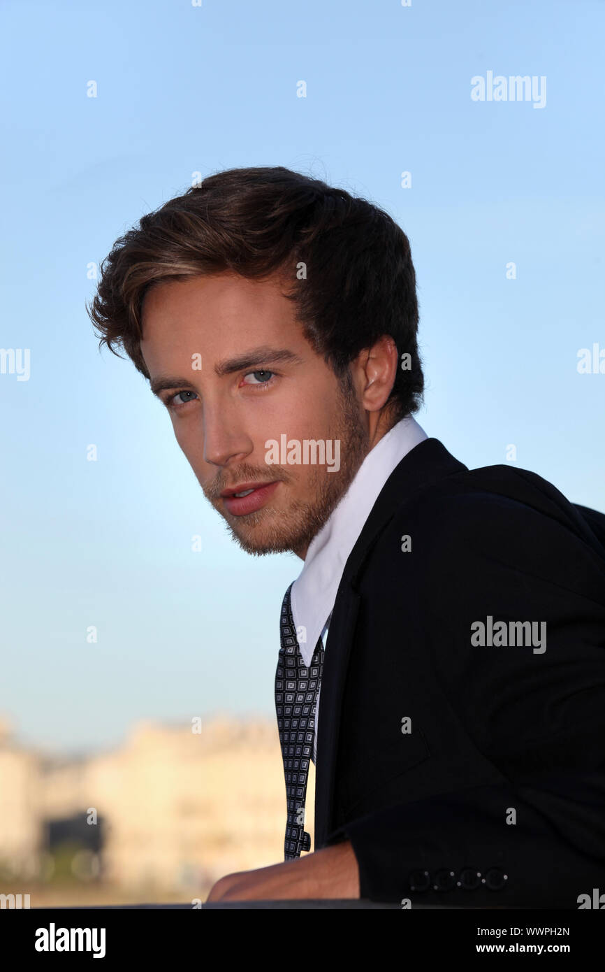 Portrait of a young man in suit Stock Photo - Alamy