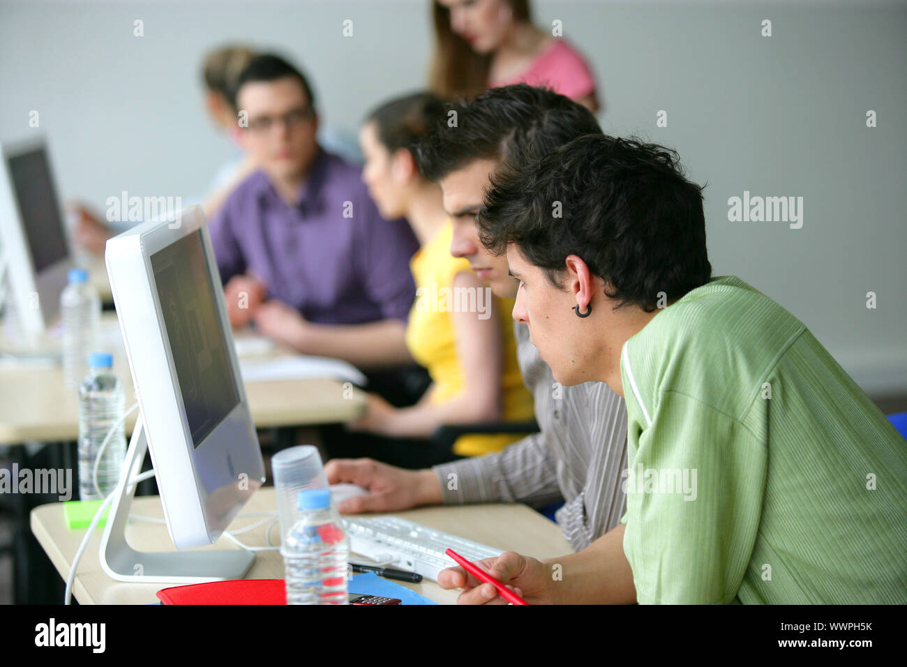 Young men using a computer in the classroom Stock Photo - Alamy