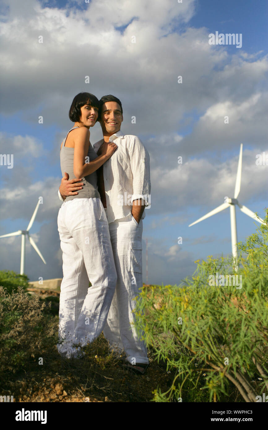 Couple in front of wind farm Stock Photo - Alamy
