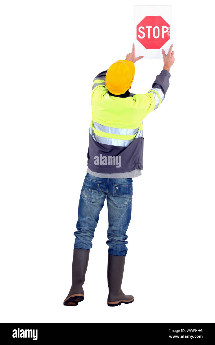 Worker with stop sign Stock Photo - Alamy
