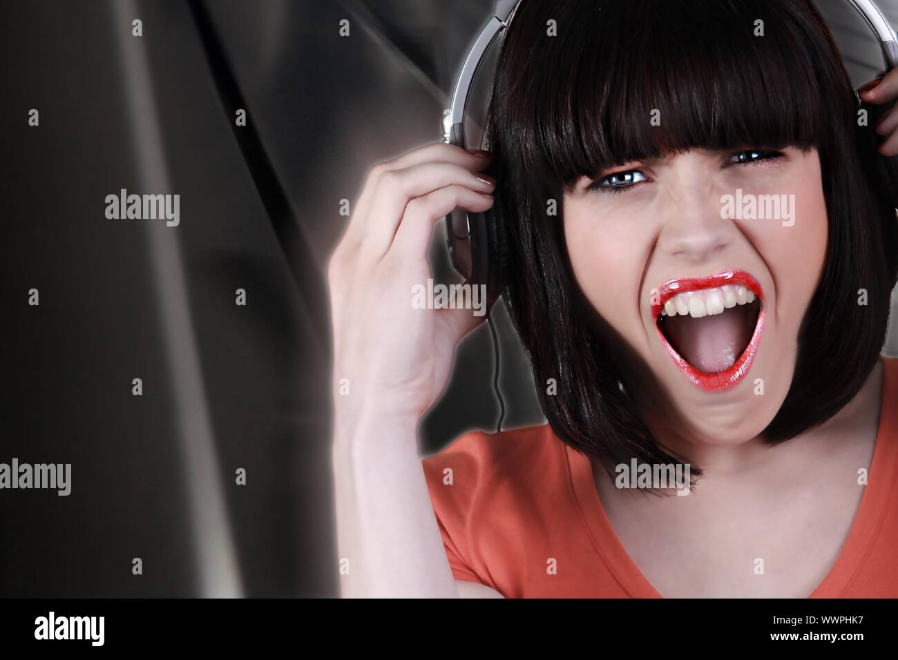 brunette wearing headset shouting Stock Photo - Alamy