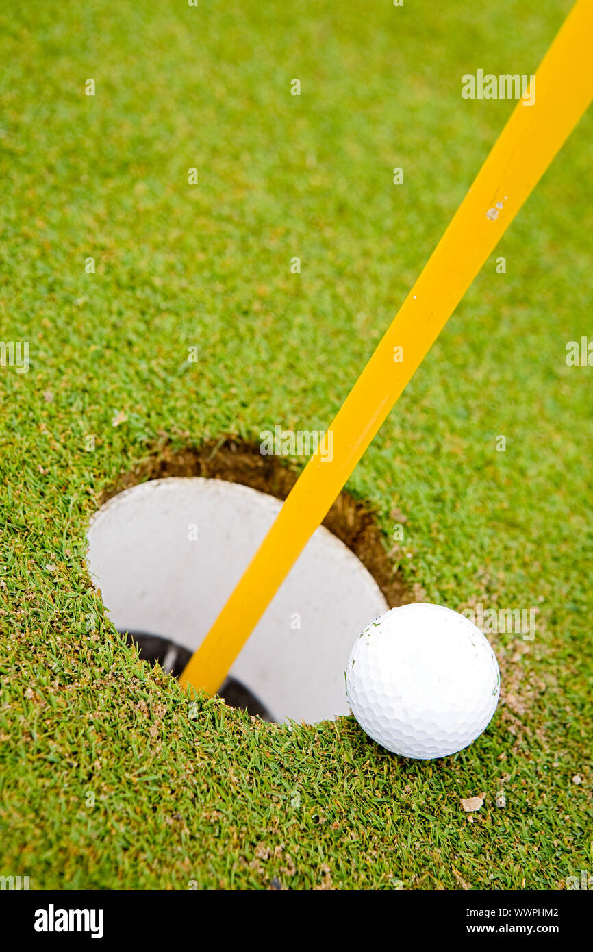 Golf ball very close to going in the hole Stock Photo - Alamy
