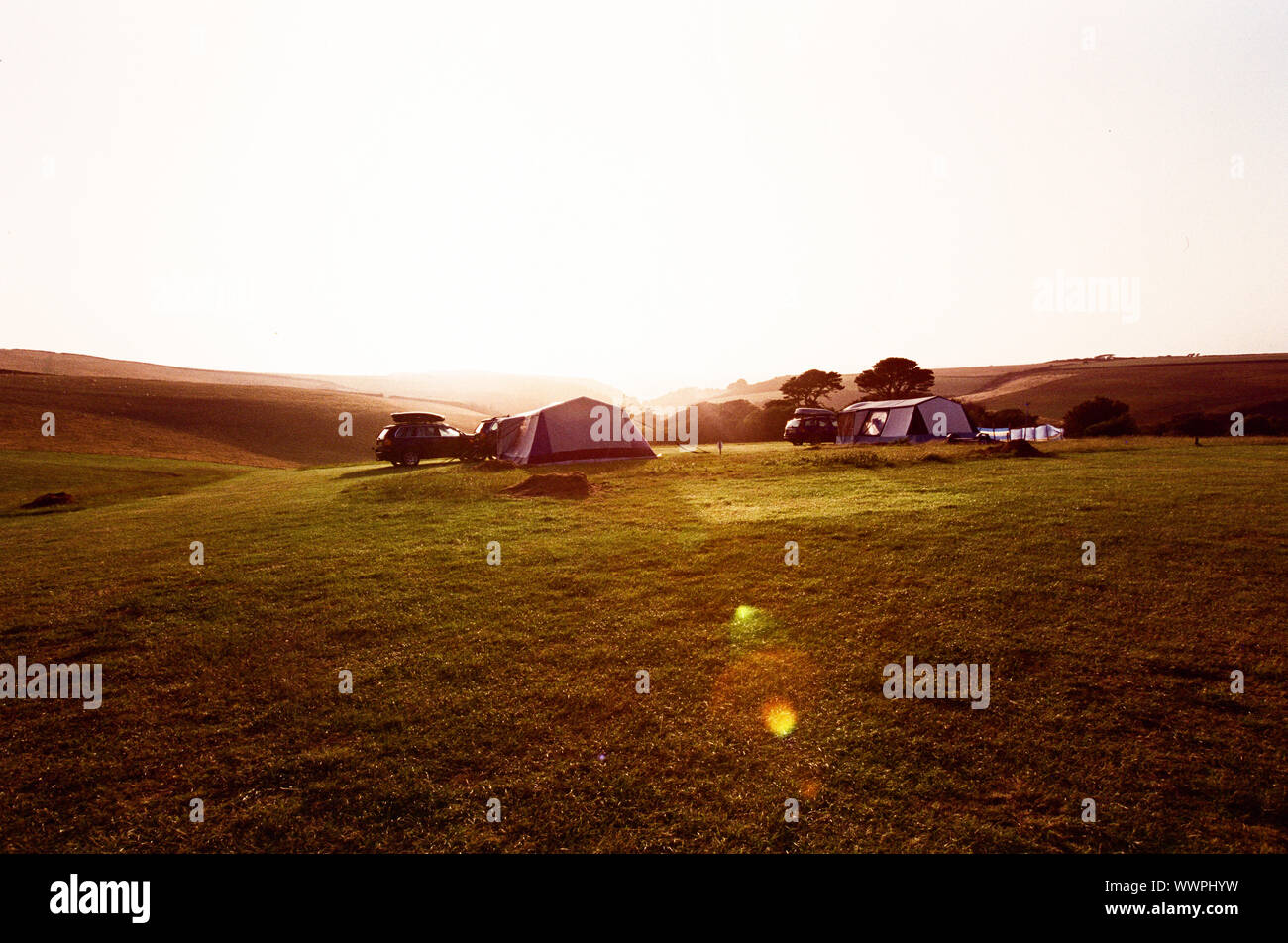 Sunsetting over tents at Karrageen camping and caravan site, Hope Cove ...