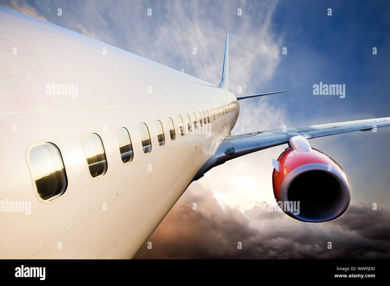 An airplane in flight over a blue sky Stock Photo - Alamy