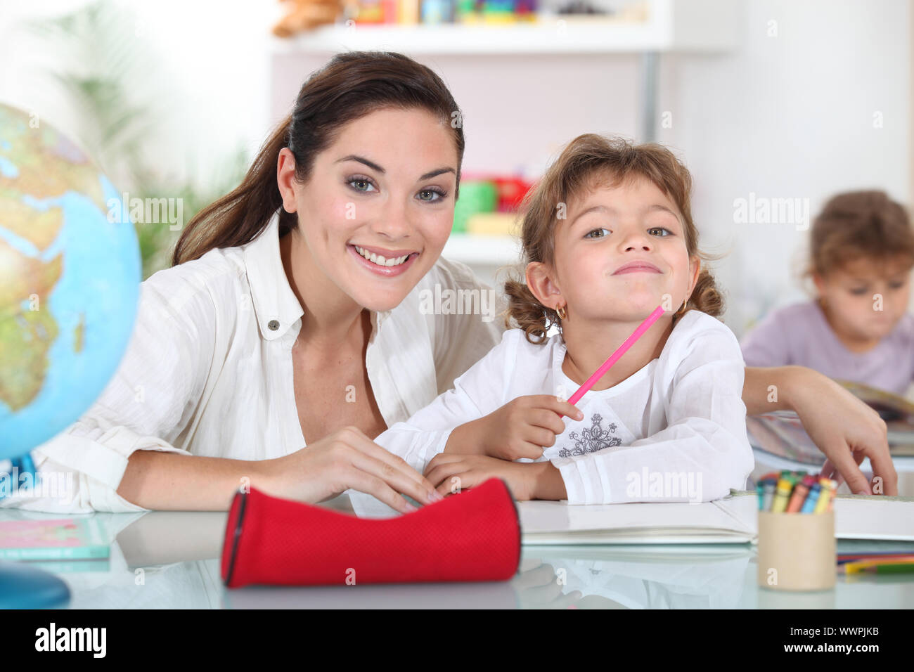 Teacher with a little girl Stock Photo - Alamy