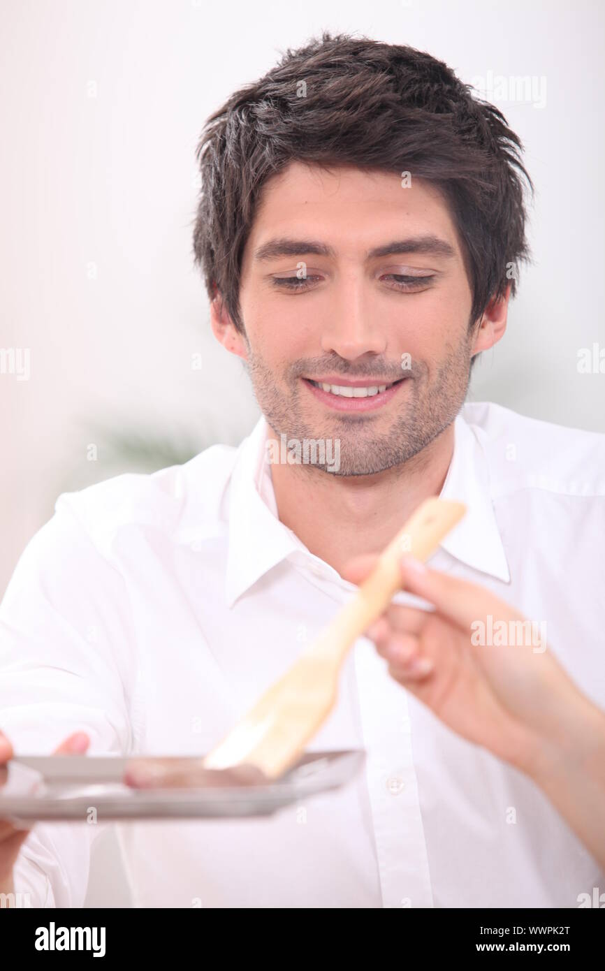 Man being served food Stock Photo - Alamy