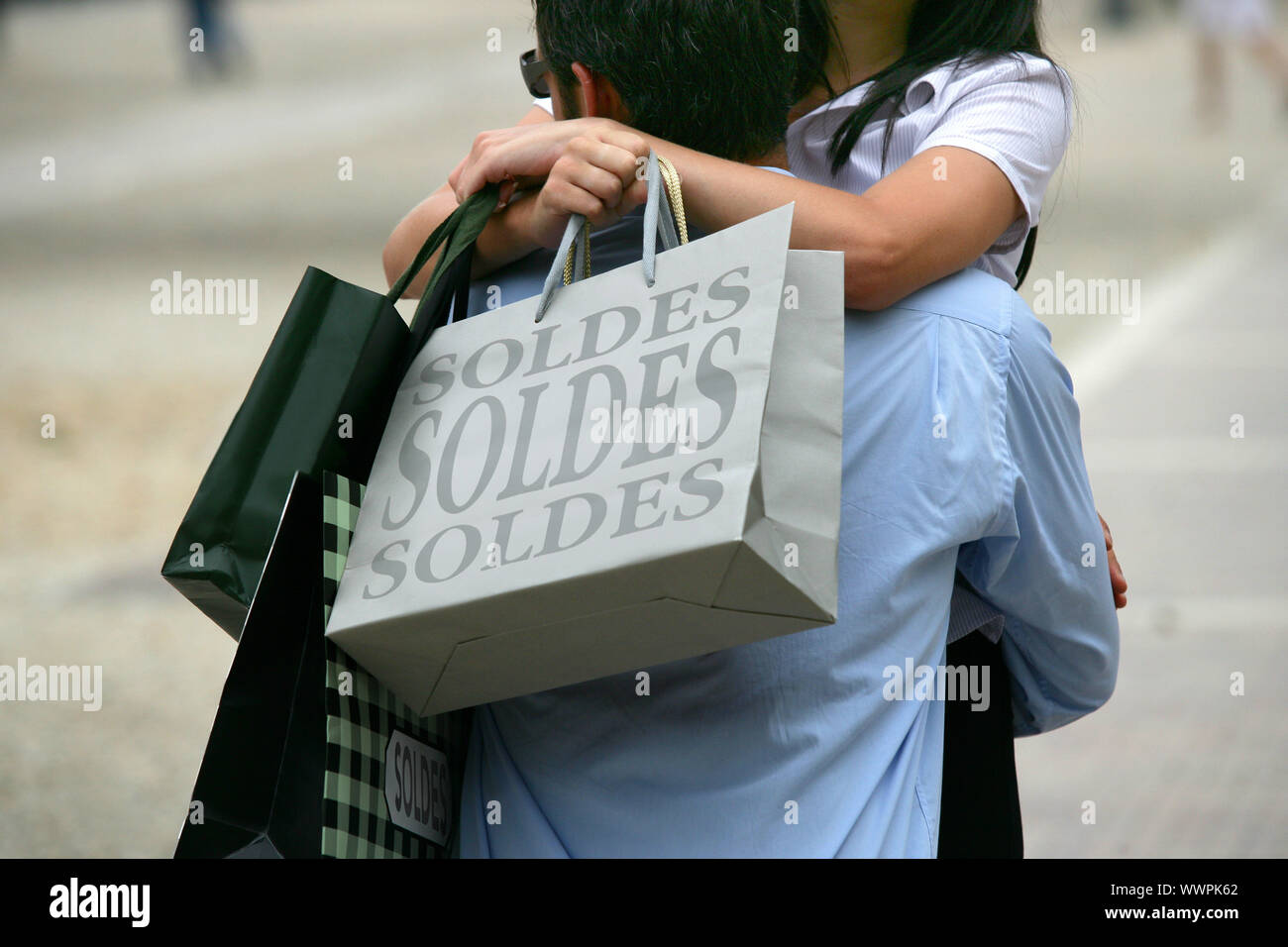 Couple hugging with shopping bags Stock Photo - Alamy