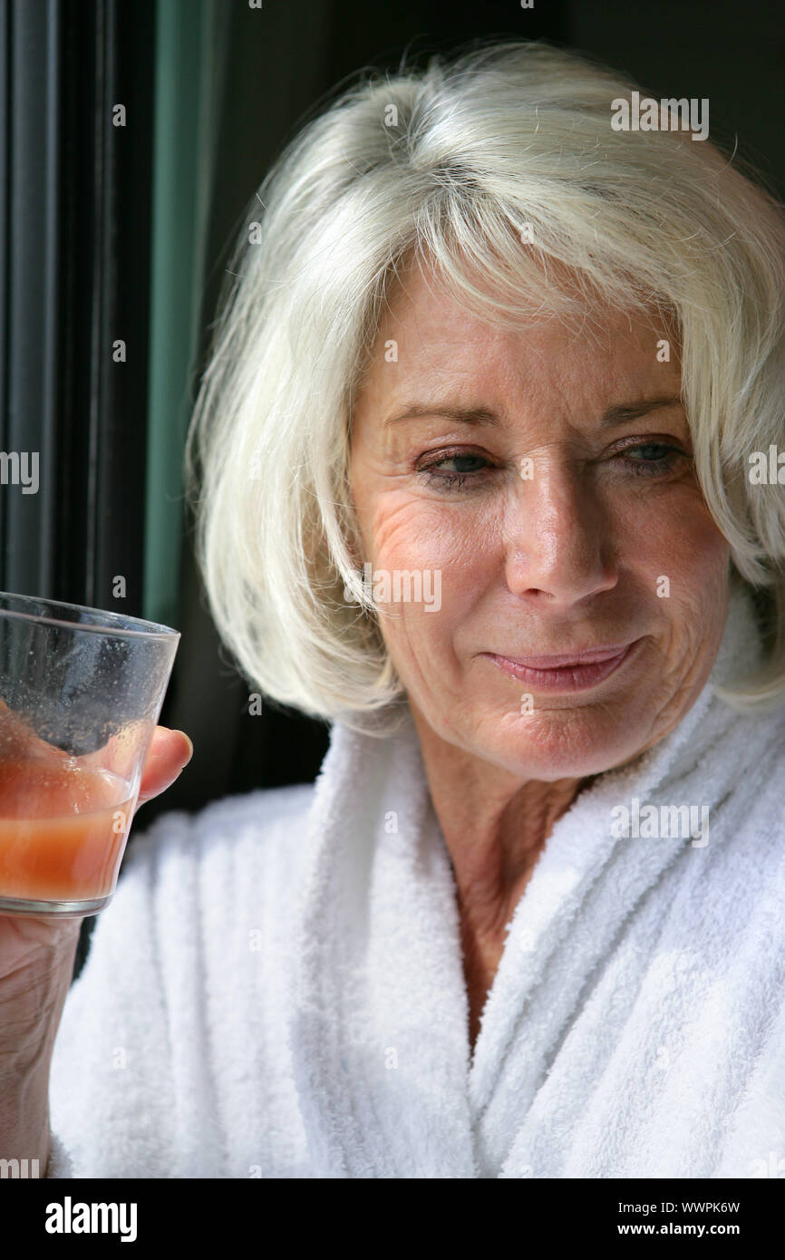 Elderly woman drinking fruit juice hi-res stock photography and images - Alamy
