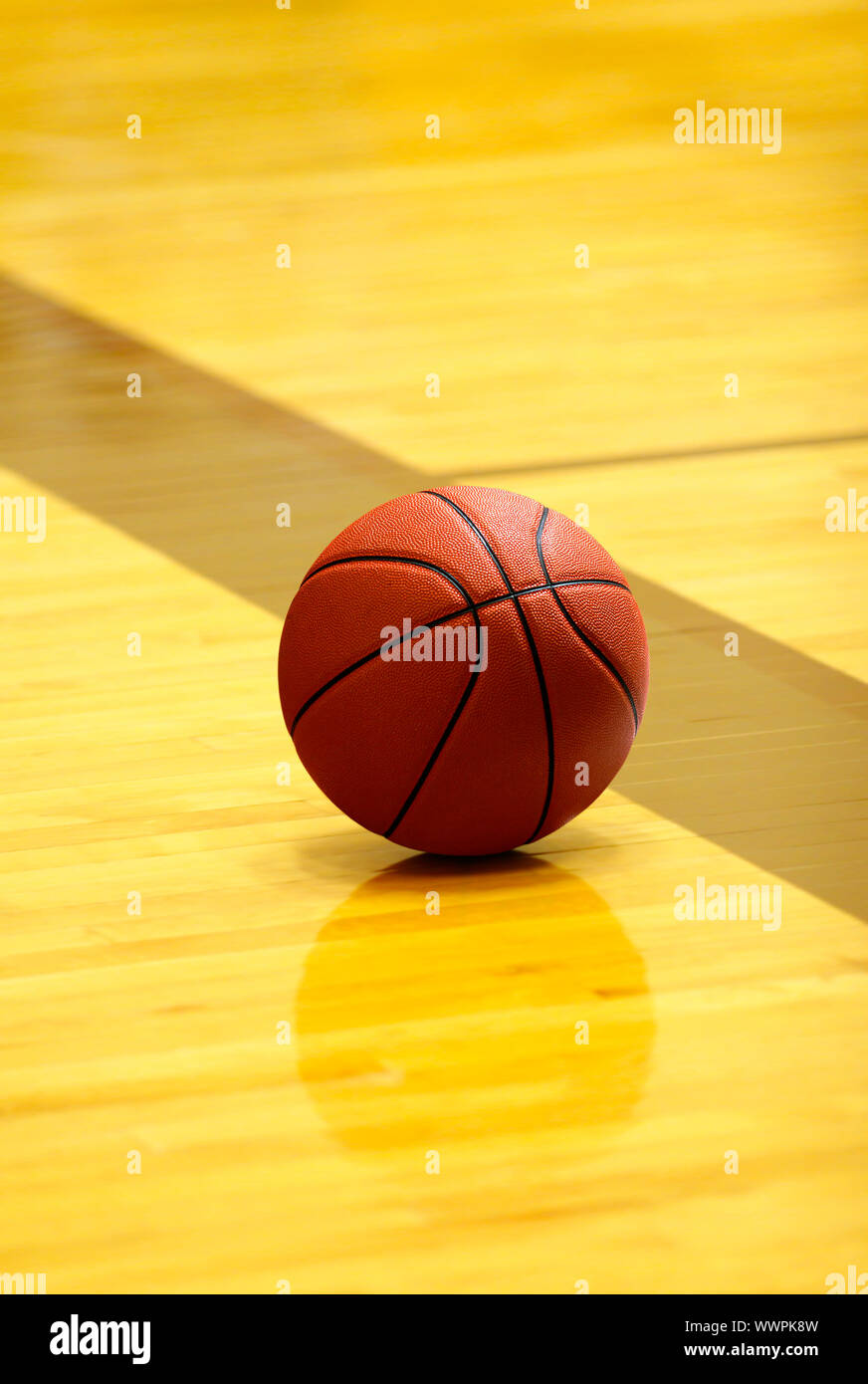 orange basket ball on yellow court at break time Stock Photo - Alamy