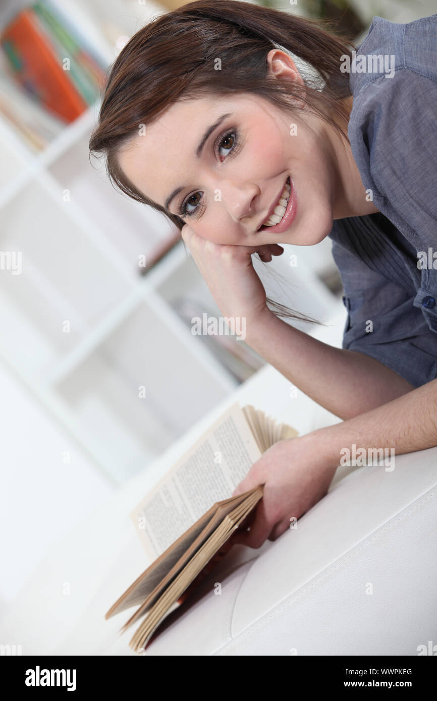 Young woman relaxing reading a book Stock Photo - Alamy