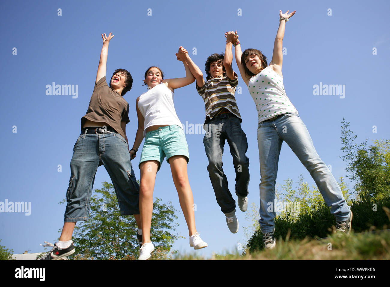 Happy teenagers jumping in air Stock Photo - Alamy