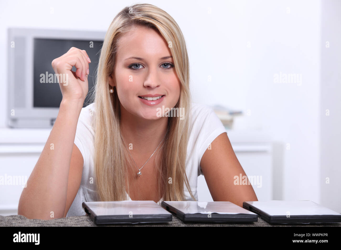 Teenage girl choosing DVD Stock Photo - Alamy