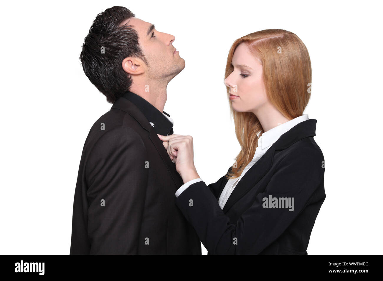a woman helping a man to dress his shirt Stock Photo - Alamy