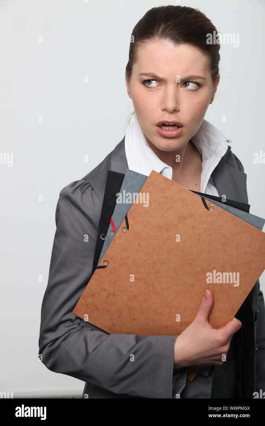 Confused office worker with paperwork Stock Photo - Alamy