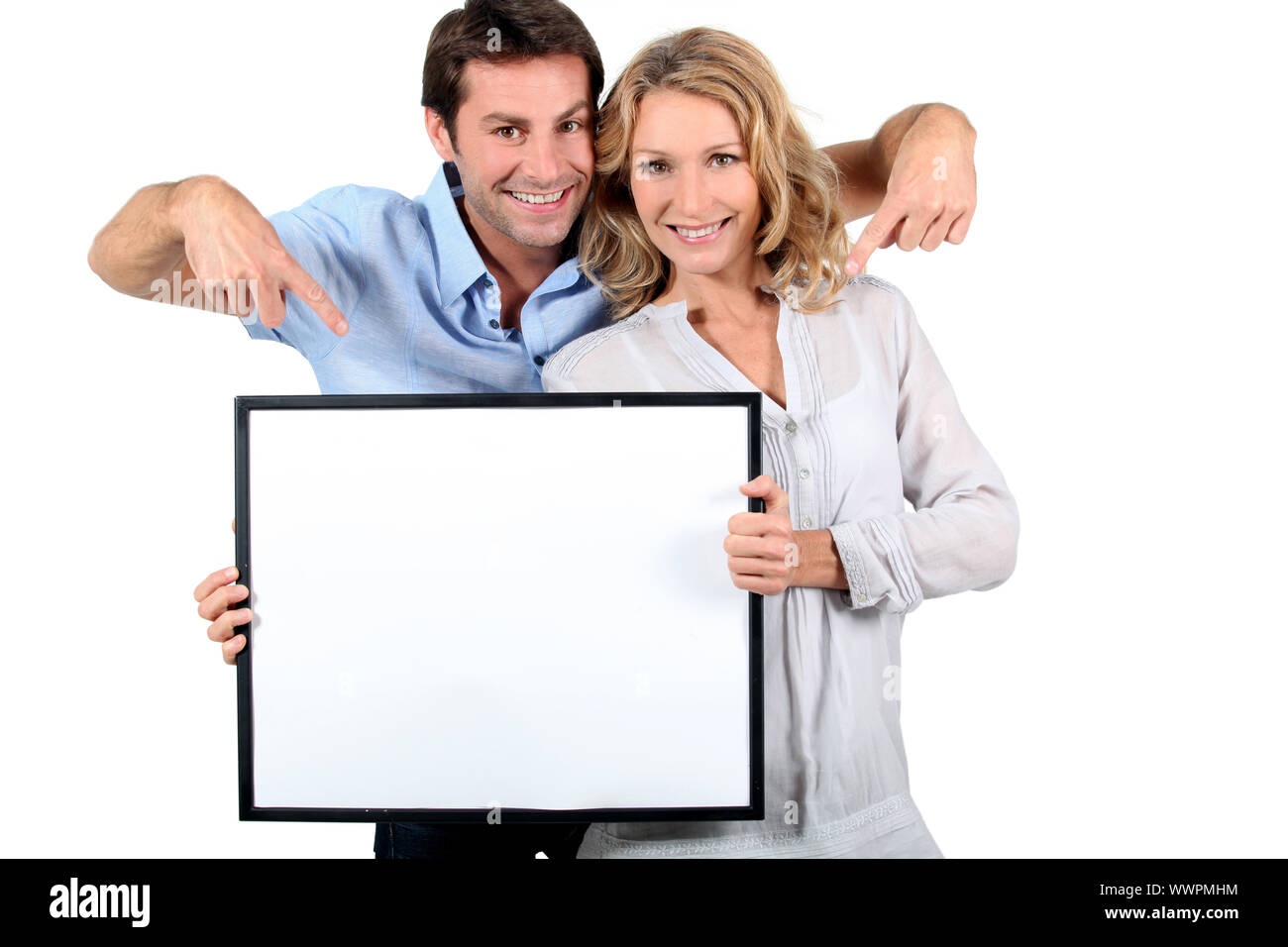 couple holding a frame Stock Photo - Alamy