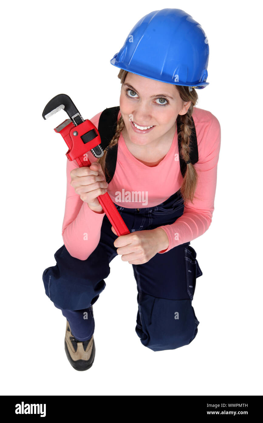 Female plumber kneeling with wrench Stock Photo - Alamy