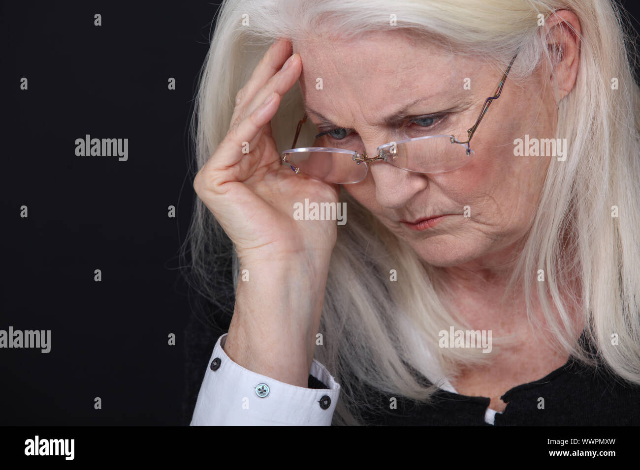 Old lady suffering from headache Stock Photo - Alamy