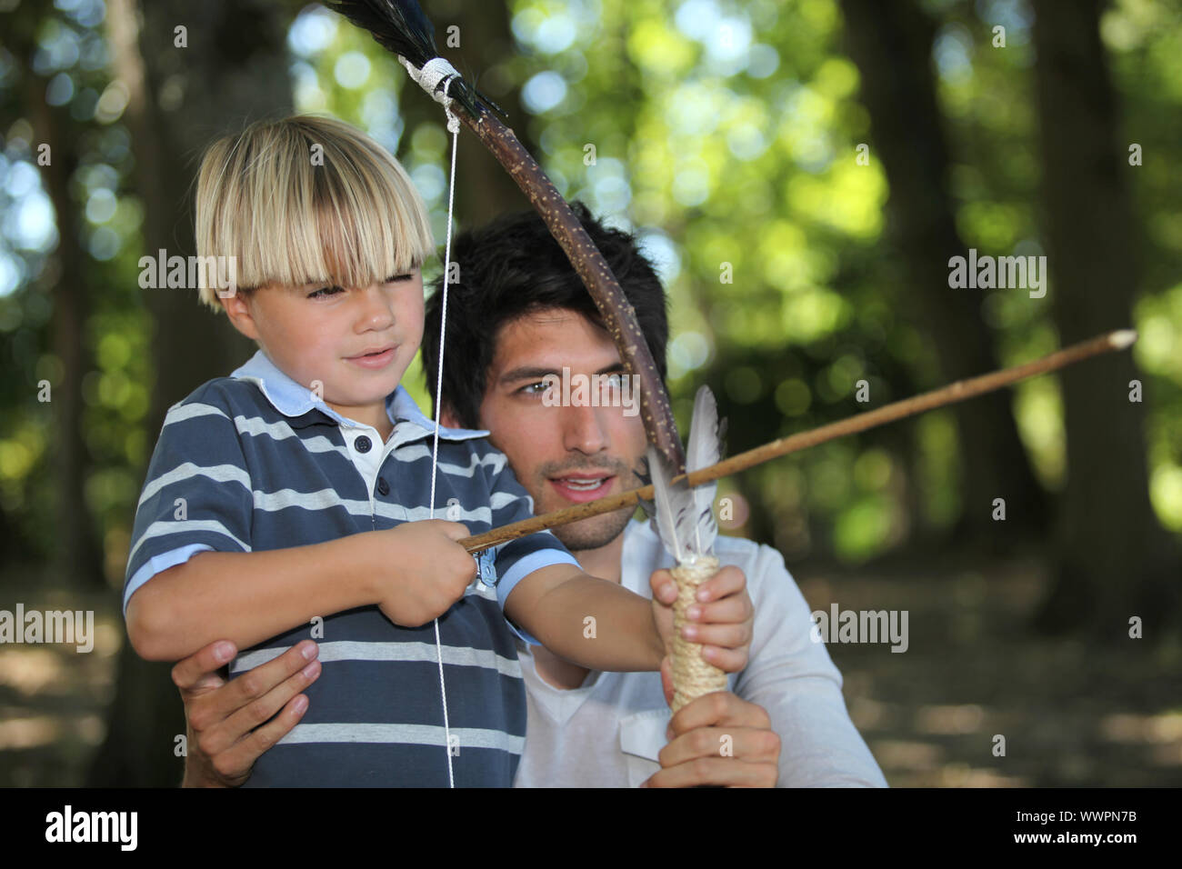 Father teaching son bow arrow hi-res stock photography and images - Alamy