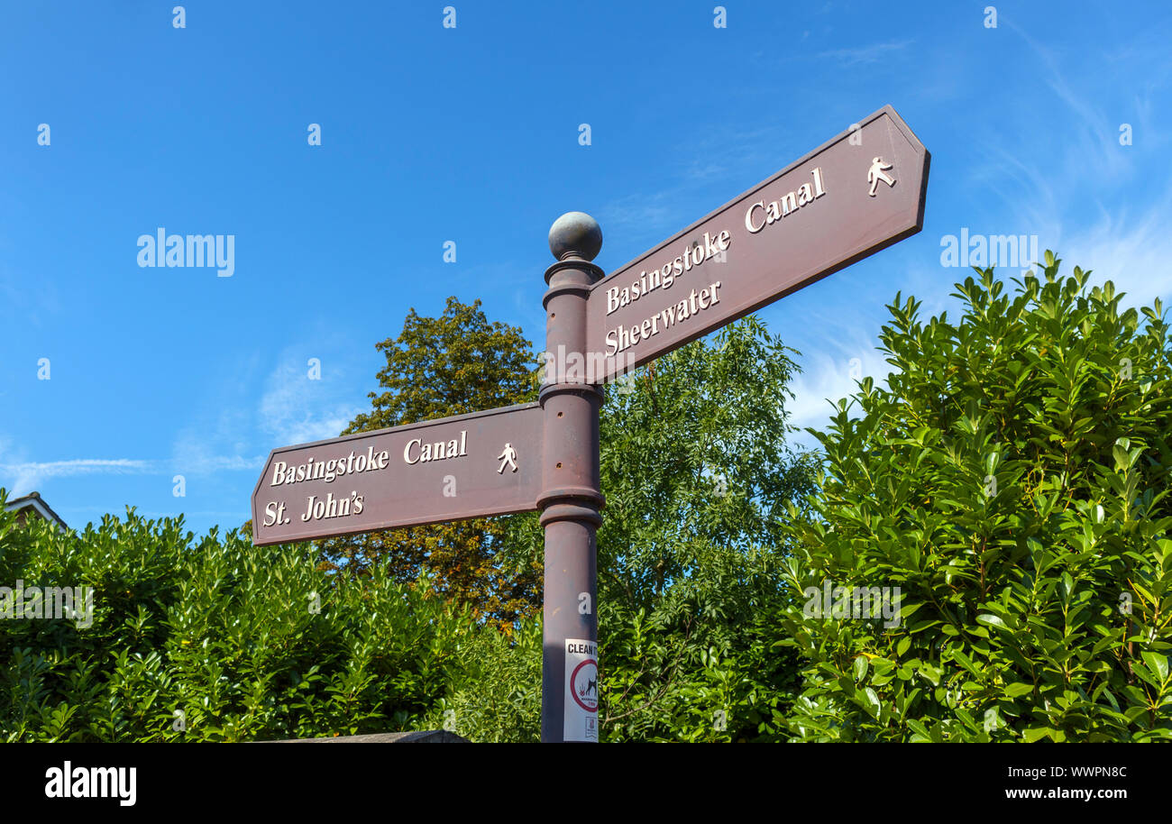 Signpost on the towpath of the Basingstoke Canal in Woking giving ...