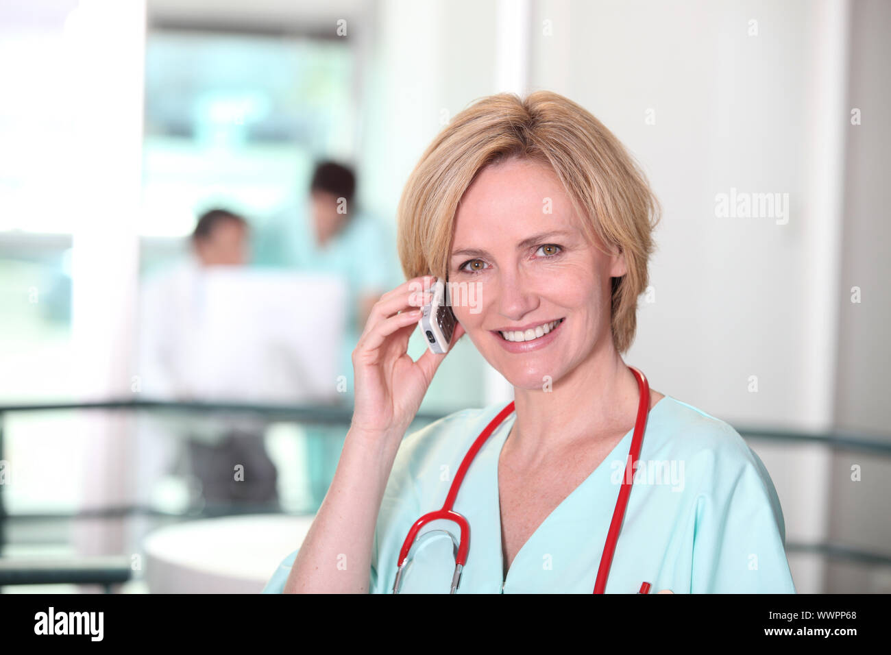 Nurse on mobile phone Stock Photo - Alamy