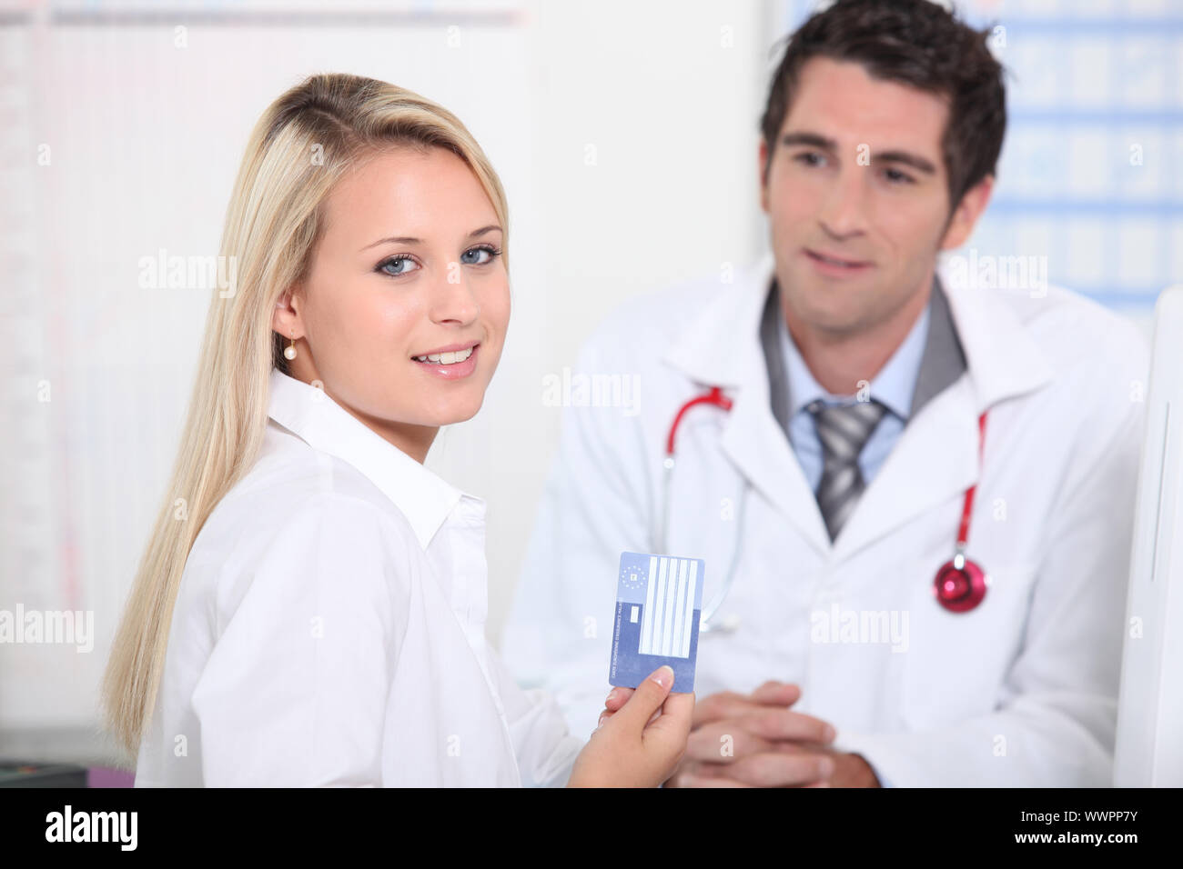 Young female patient registering her details Stock Photo - Alamy