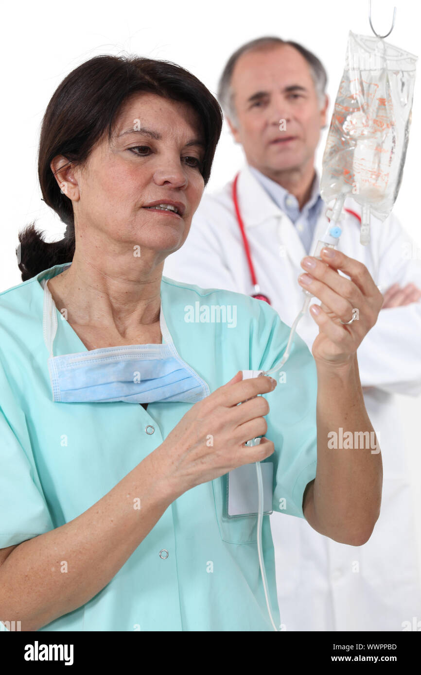 Doctor and nurse with IV drip Stock Photo - Alamy