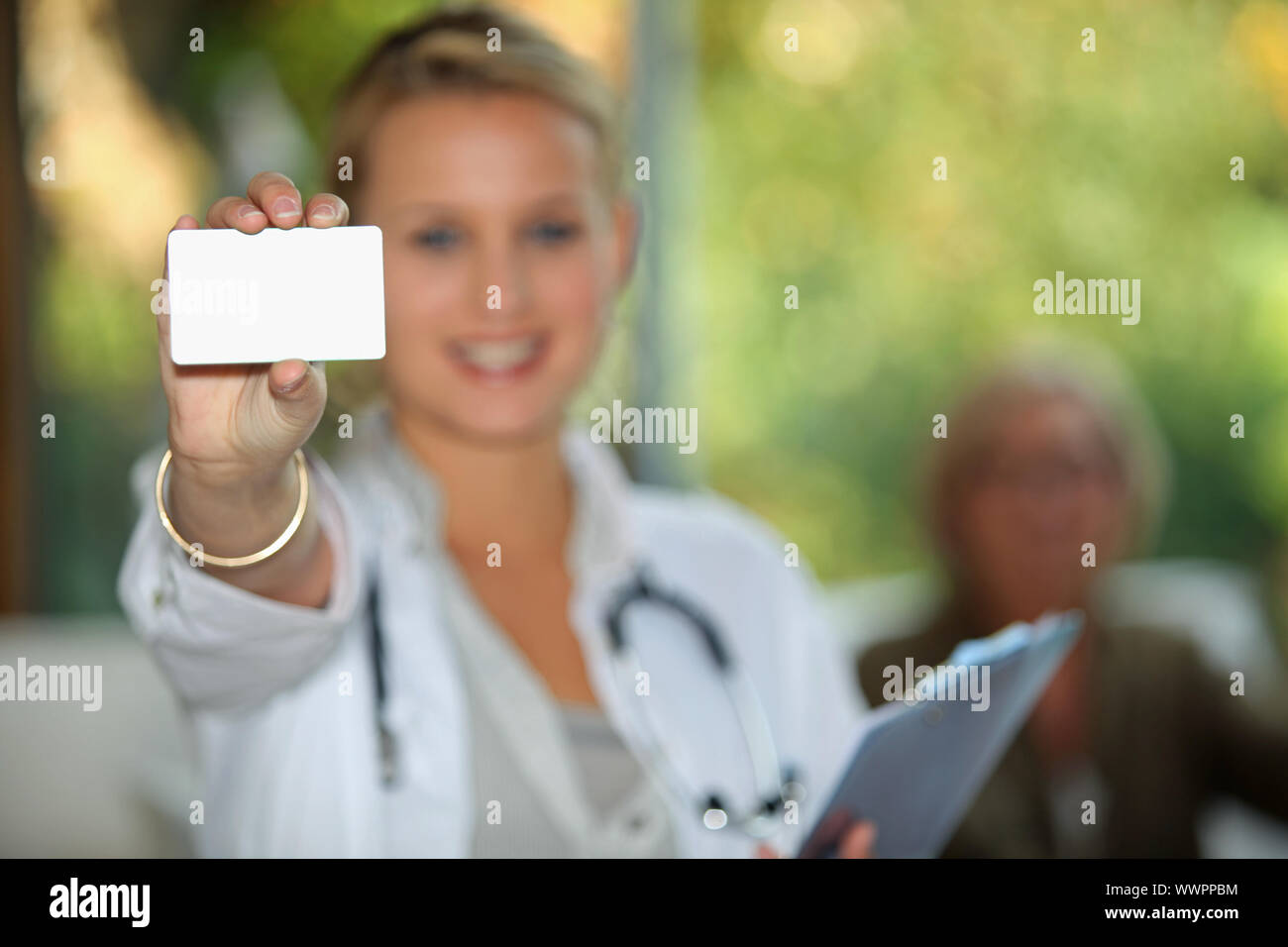 Doctor showing business card Stock Photo - Alamy