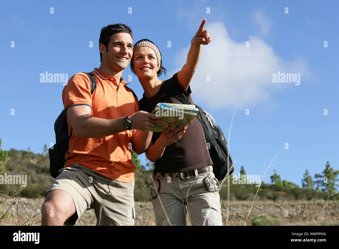 Explorers reading a map Stock Photo - Alamy