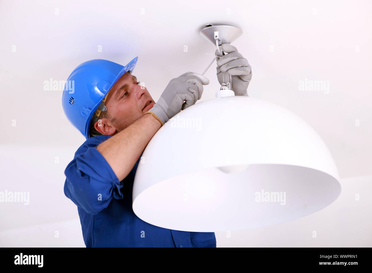 Installing the ceiling light Stock Photo - Alamy