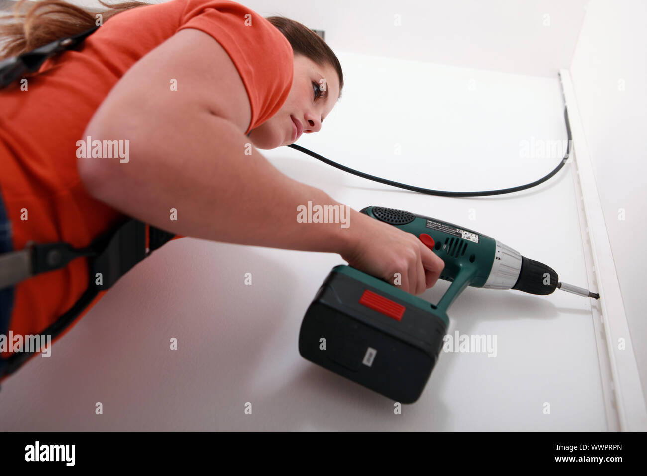 pretty girl tinkering Stock Photo - Alamy