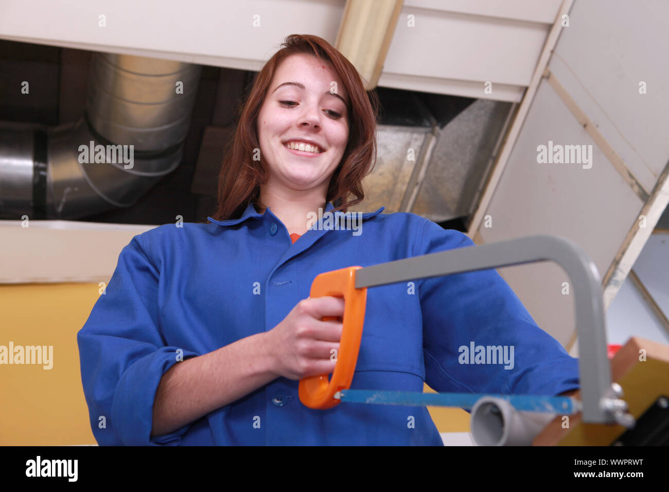 Woman using a hacksaw Stock Photo - Alamy