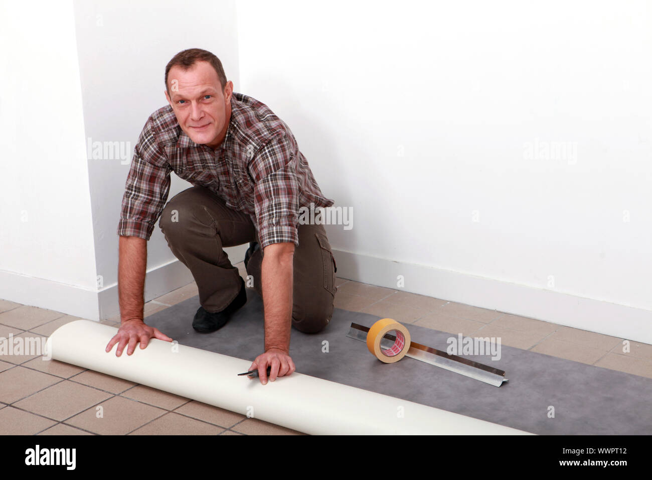 Man laying carpet Stock Photo - Alamy