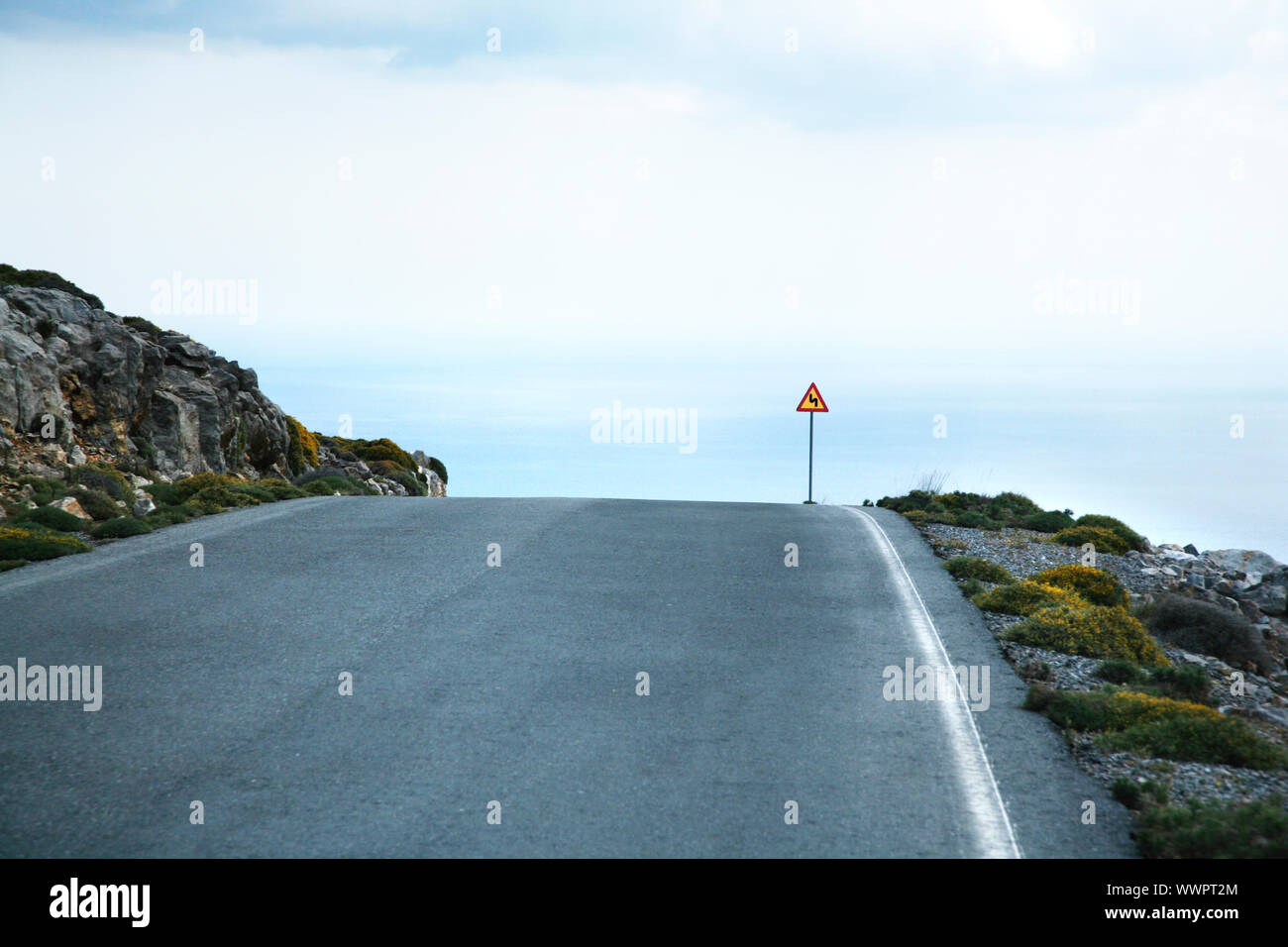 road sign of dangerous curve at crete greece Stock Photo - Alamy