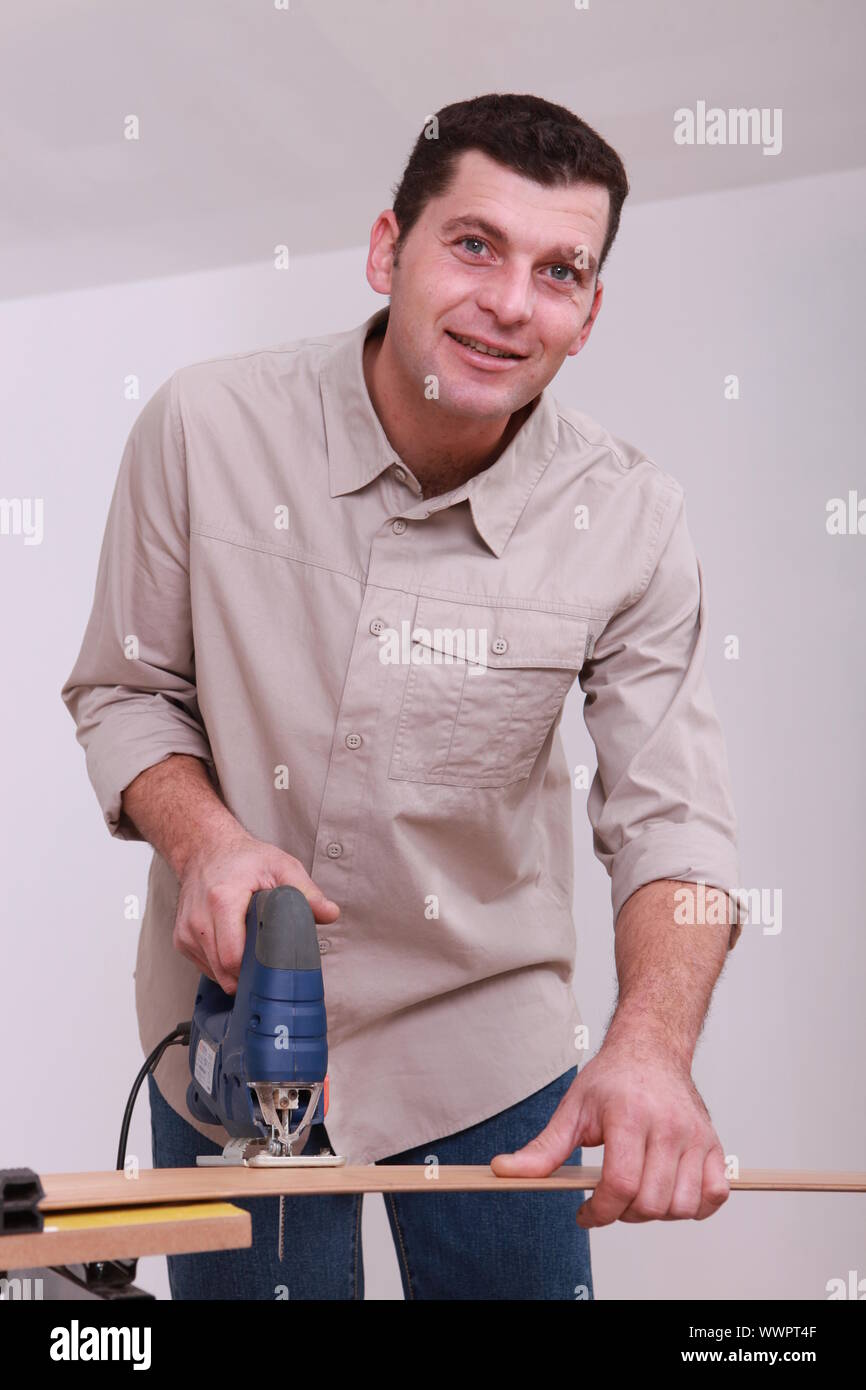 Man using a jigsaw Stock Photo - Alamy