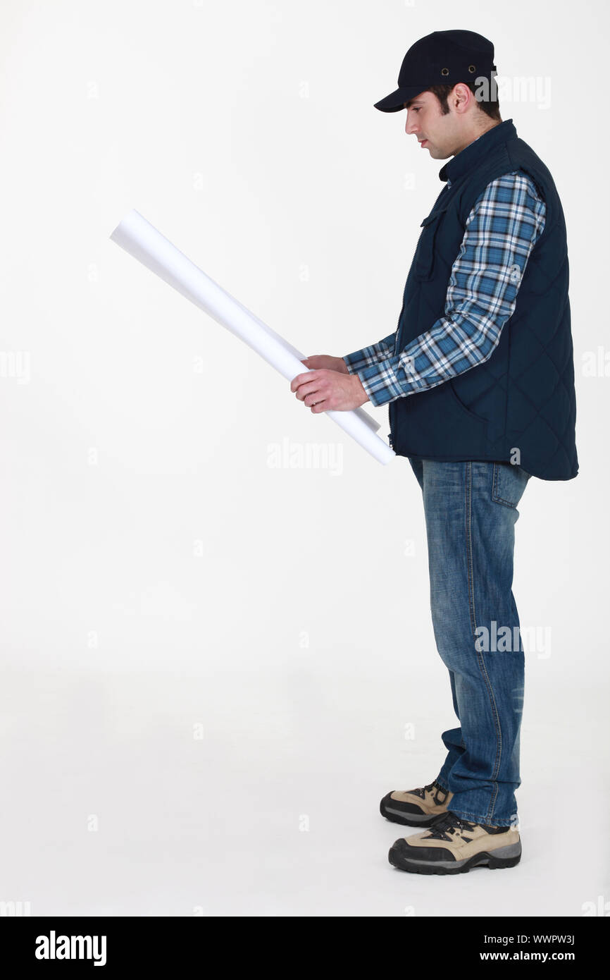 Builder with architectural plans Stock Photo - Alamy