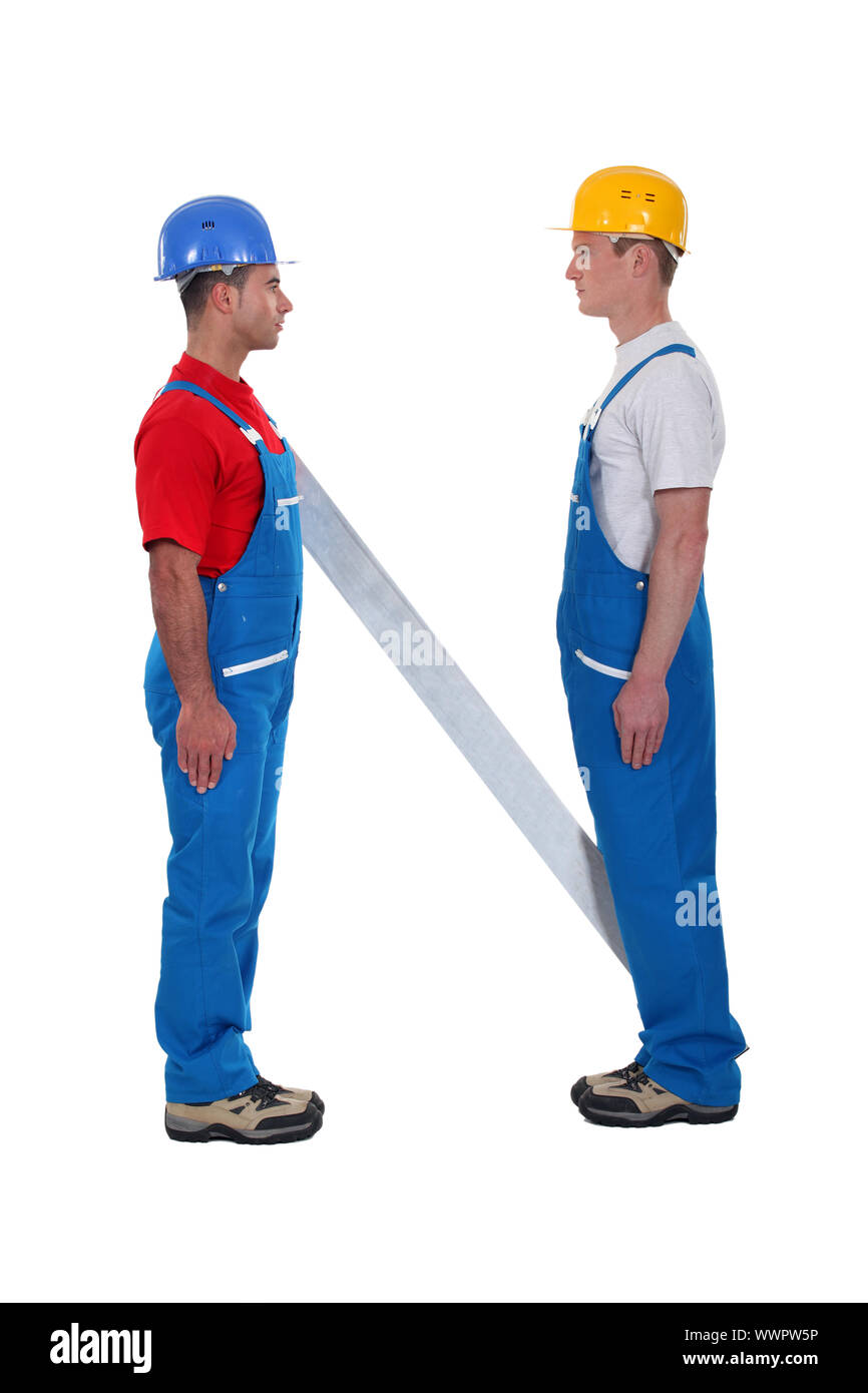 Two builders forming letter N Stock Photo - Alamy