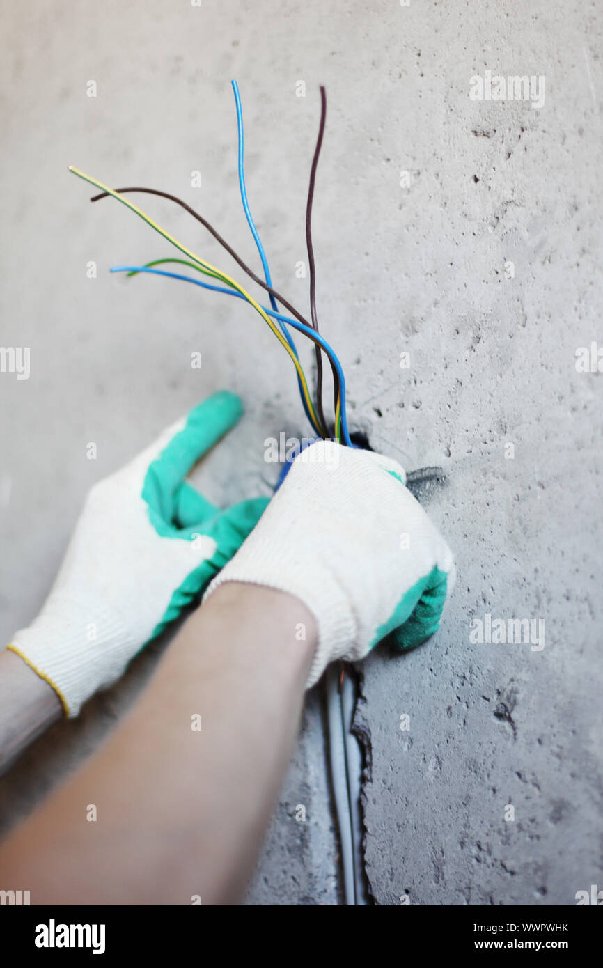 worker puts the wires in the wall Stock Photo - Alamy
