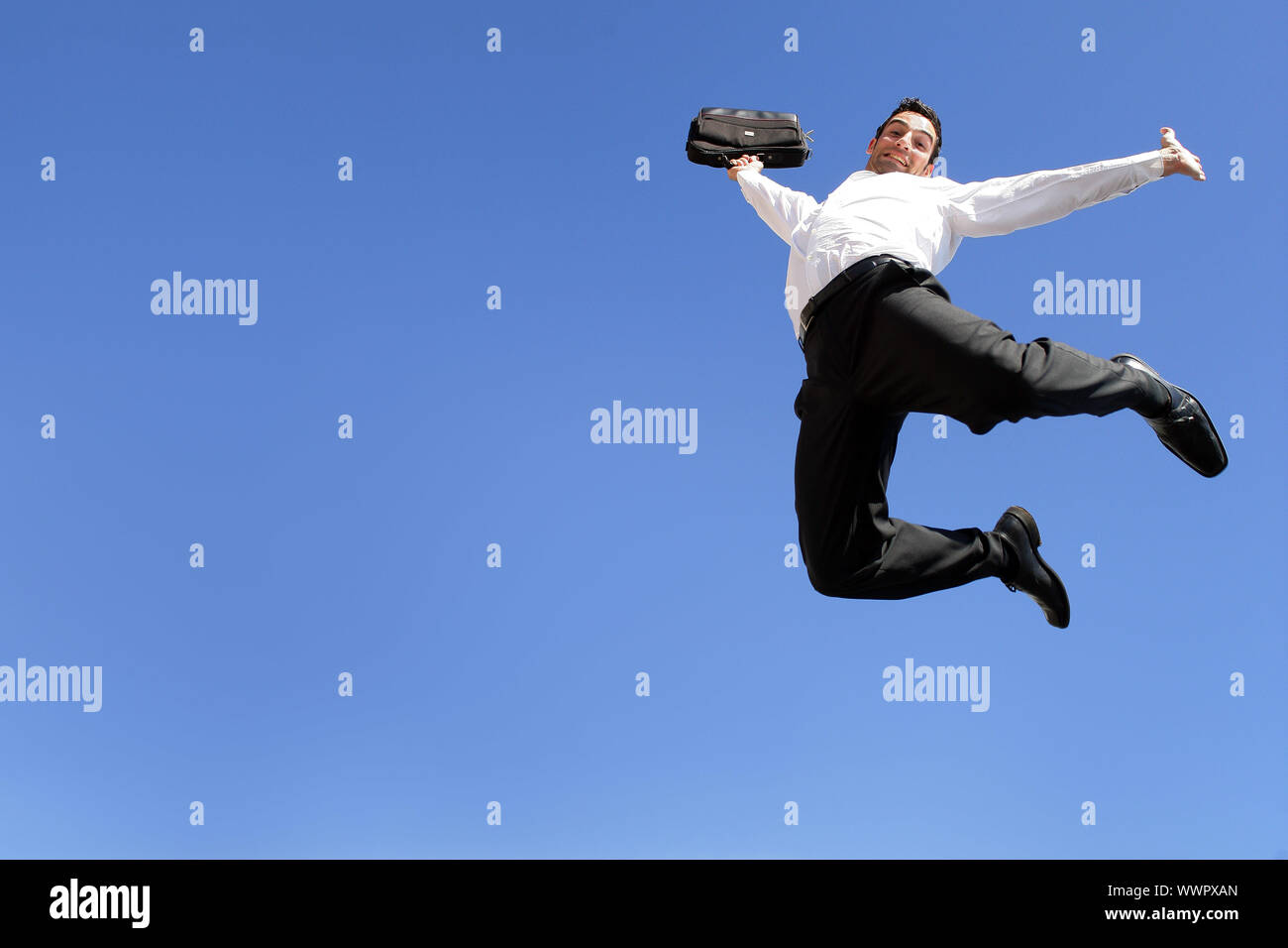 Young entrepreneur jumping in air Stock Photo - Alamy
