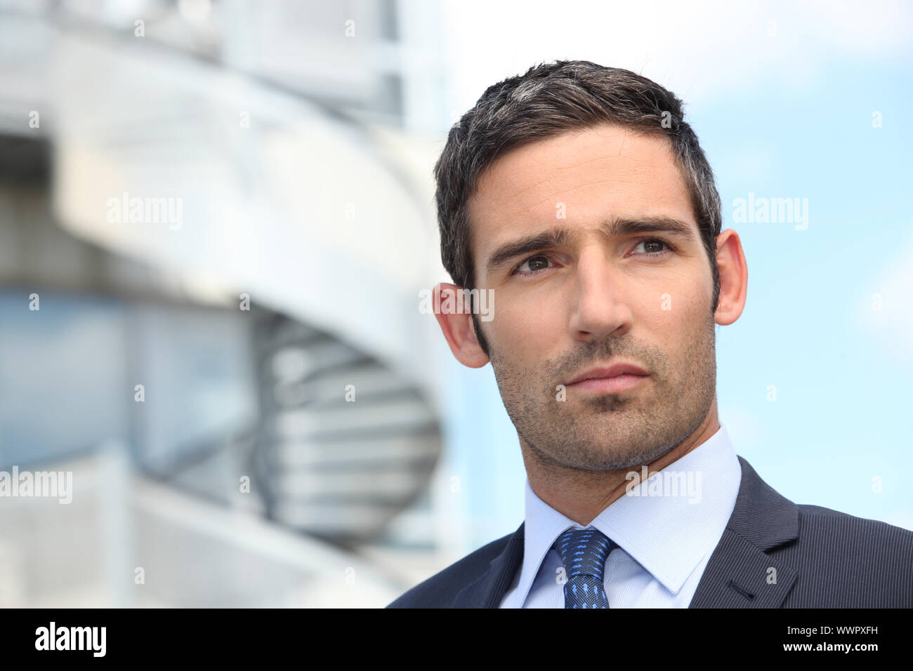 Smart man looking away outdoors Stock Photo - Alamy