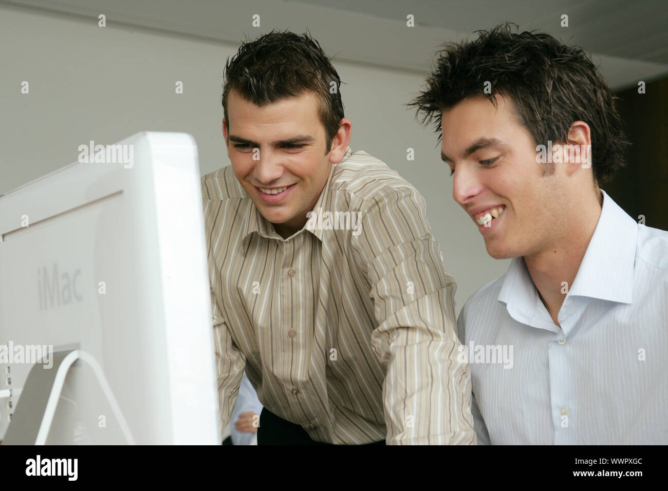 Young men learning computer skills Stock Photo - Alamy