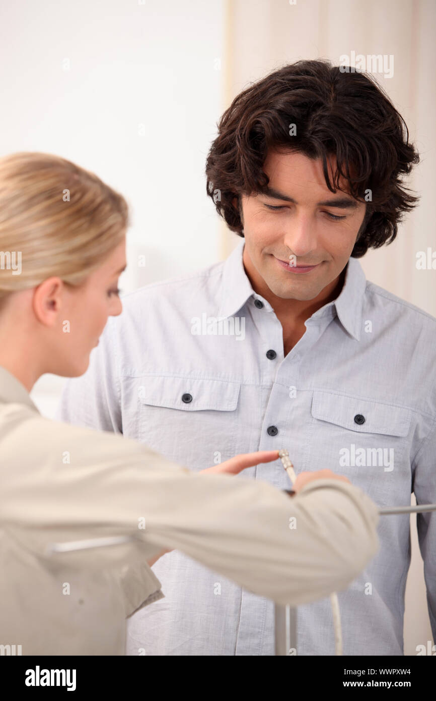 Man and woman looking in detail at something Stock Photo - Alamy